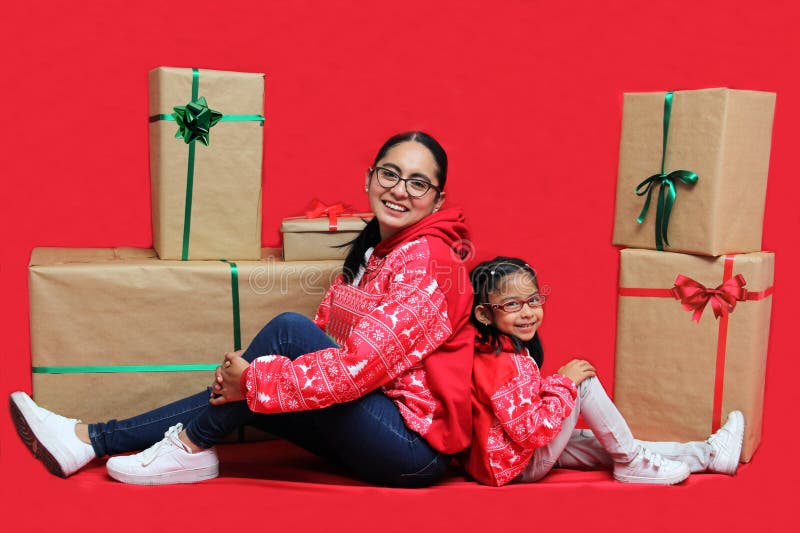 Latina Mom And Daughter With Glasses Wear Ugly Christmas Sweaters And Show Their Love To Each
