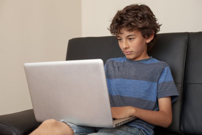 Latino Boy Sitting on Sofa with Laptop Computer Stock Photo - Image of ...