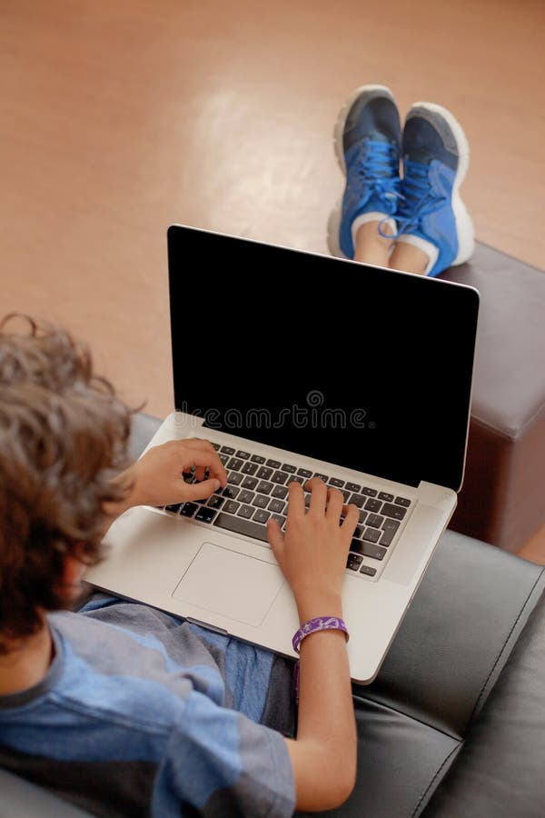 Latino Boy Sitting on Sofa with Laptop Computer Stock Photo - Image of ...