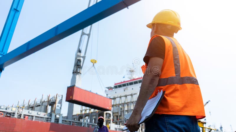 Latino Cargo Supervising Engineer Seen from Behind Guaranteeing ...