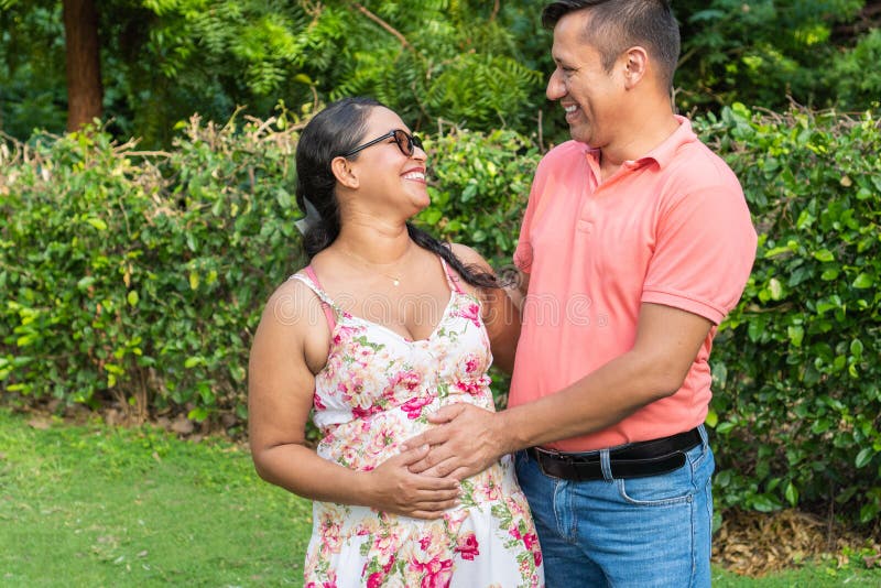 Latino Man Touching His Pregnant Wife`s Belly While They Are Together