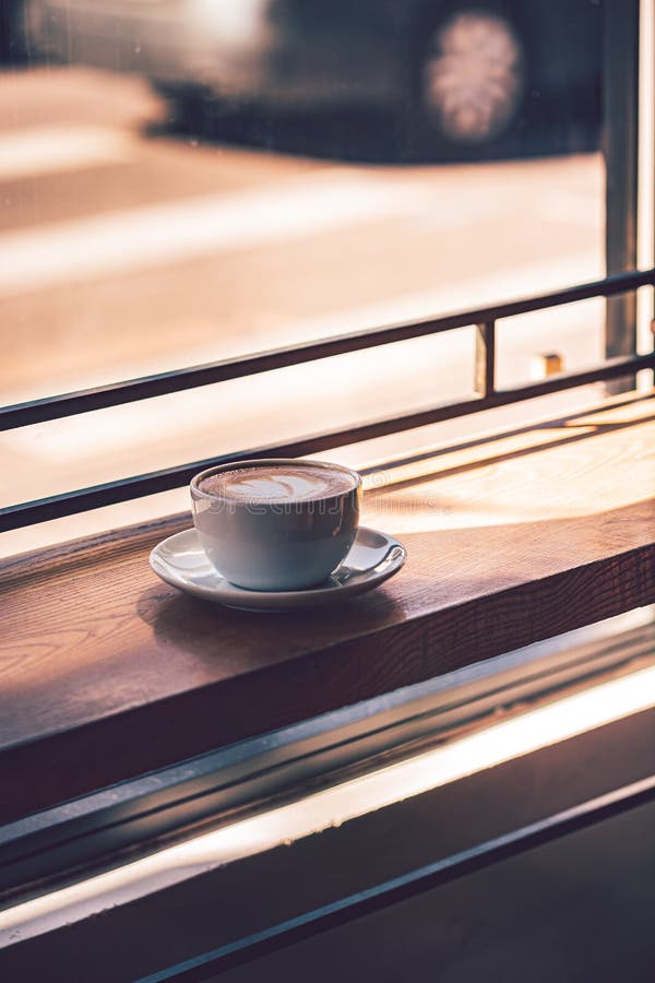 Latte Coffee in White Coffee Cup on the Wooden Table in Front of the ...