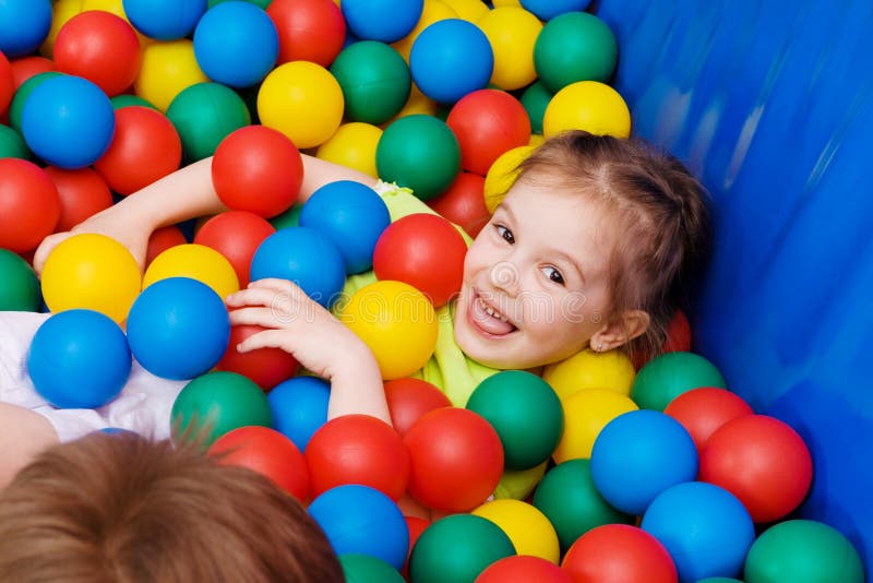 Girl Lying among Inflating Balls Stock Photo - Image of smiling, meadow ...