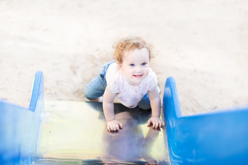 Laughing Baby Girl Playing on a Slide Stock Photo - Image of laughing ...