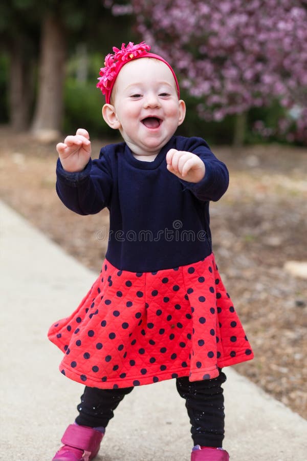 Laughing Baby Taking First Steps Stock Photo - Image of headwear, happy ...