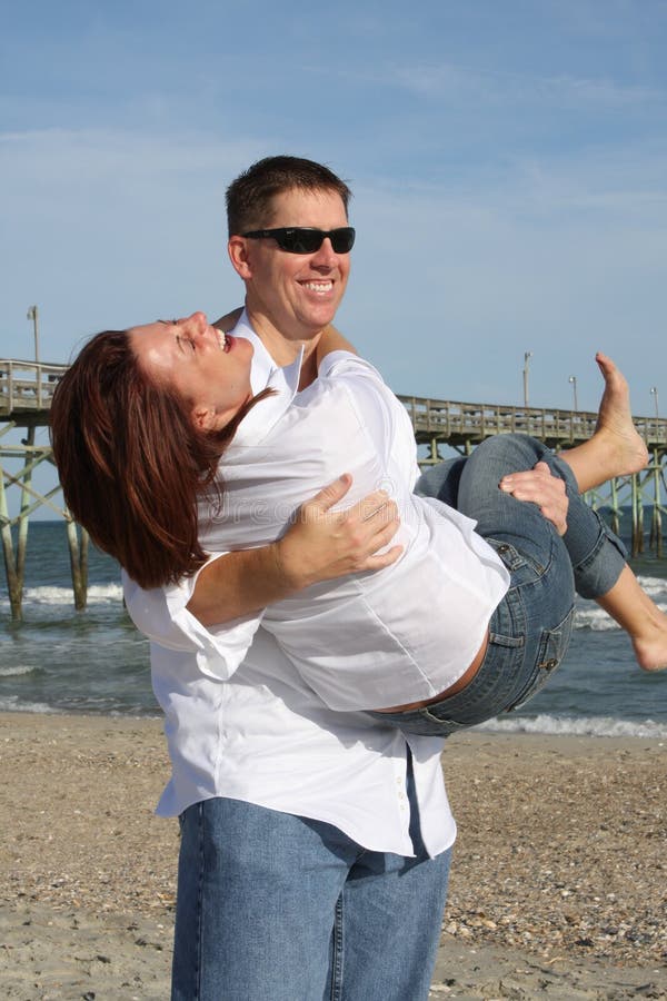 Laughing on the beach too stock image. Image of close - 9438889