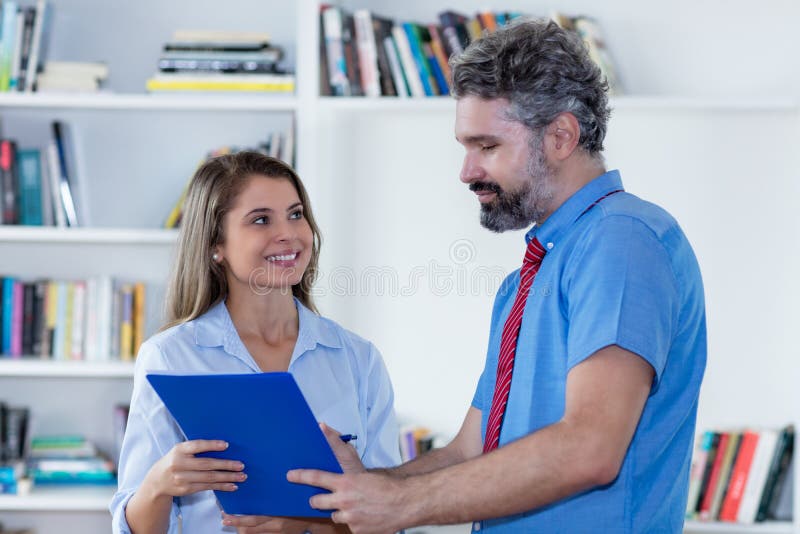 Laughing Blond Secretary Talking with Middle-aged Businessman Stock ...