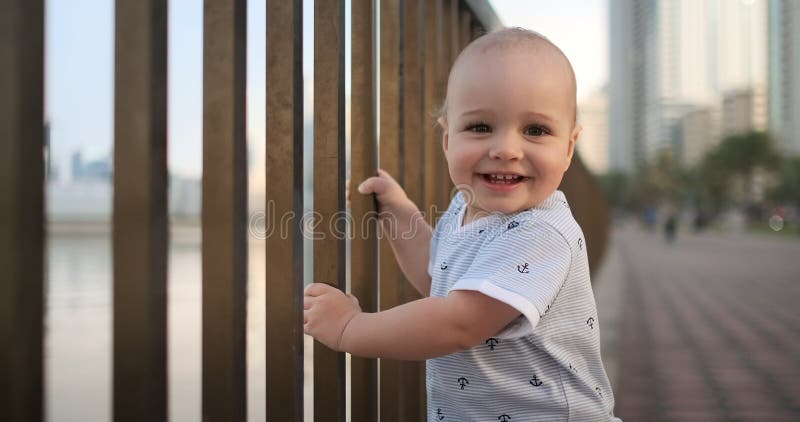 Laughing Boy at the Age of 1 Year Dancing Holding the Railing and ...