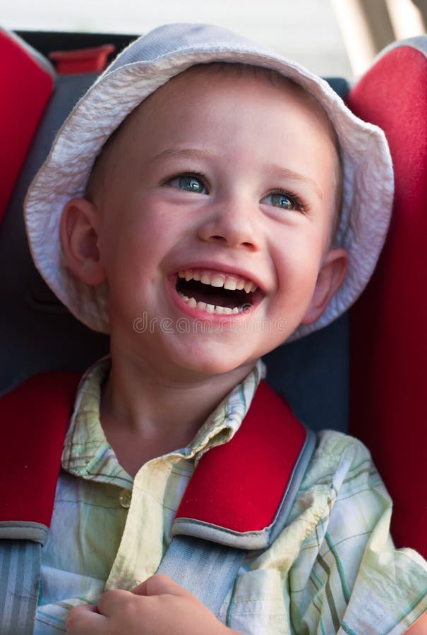 A Laughing Boy Sitting in a Booster Stock Photo - Image of ...