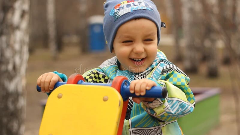Laughing Child Rocking on a Rocker in Park Stock Footage - Video of ...