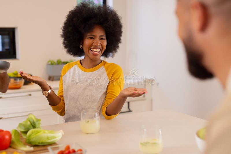 Laughing and Enjoying Conversation, Diverse Friends Sitting at Kitchen ...