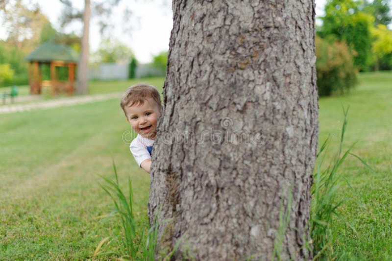 Laughing Girl Behind Tree stock image. Image of human - 41297809
