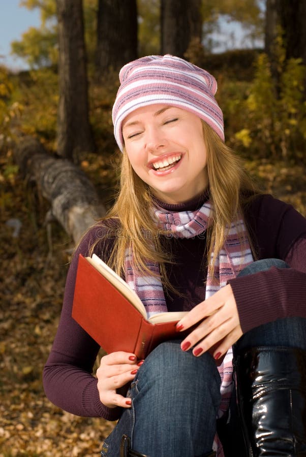 Laughing girl with a book stock photo. Image of joyful - 6627068