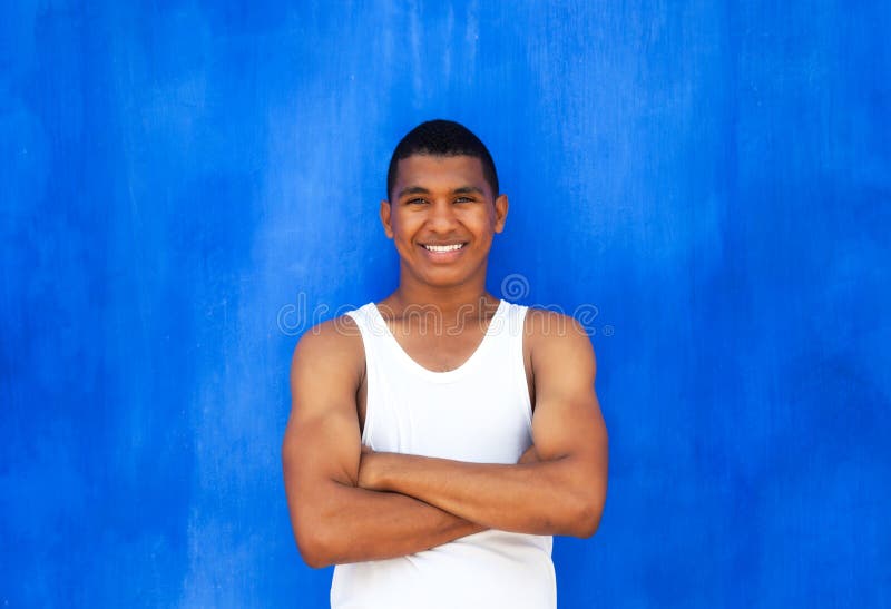 Laughing Latin Guy in Front of a Blue Wall Stock Photo - Image of blue ...