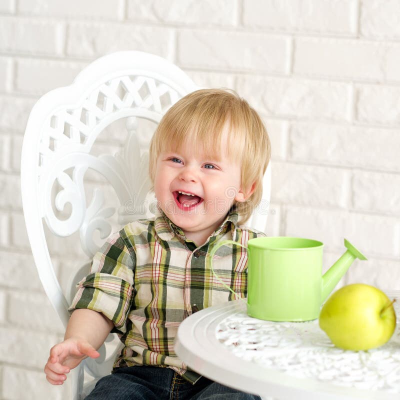 Laughing Little Boy at the Table Stock Image - Image of flower ...