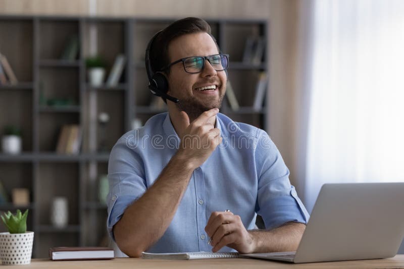 Laughing Man in Headset and Glasses Using Laptop, Taking Notes Stock ...
