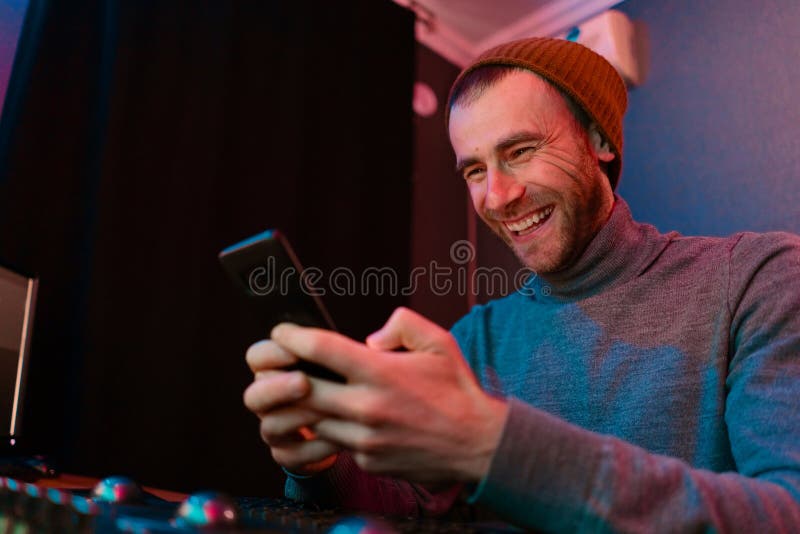 Laughing Man Portrait Holding Smartphone in His Office in Neon Lights ...