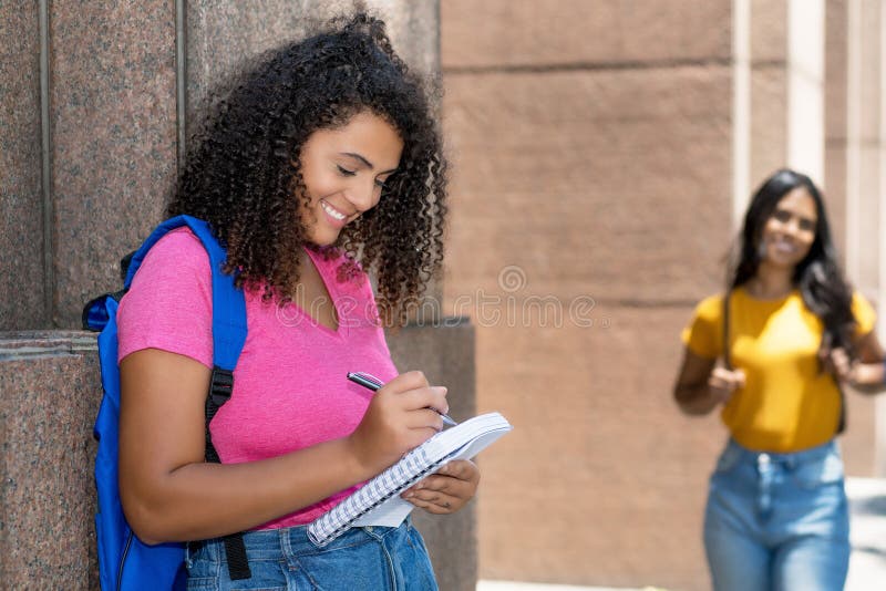 Laughing Mexican Female Student Writing Notes in Front of University ...