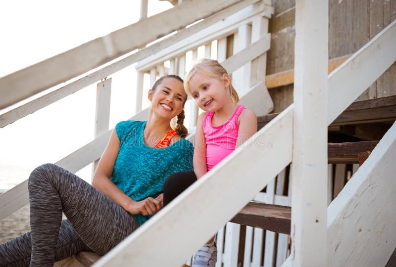 Laughing Mother and Daughter Sitting on Beach House Steps Stock Image ... Laughing Mother and Daughter Sitting on Beach House Steps Stock Image ...