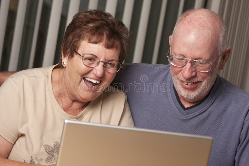 Laughing Senior Adult Couple Having Fun on the Computer Stock Photo ...