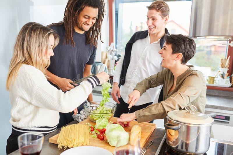Laughing Students Prepare Salad Together in Shared Kitchen Stock Photo ...
