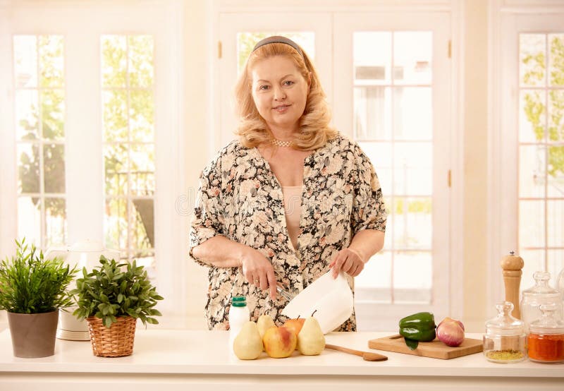 Laughing woman in kitchen stock photo. Image of apples - 23095944