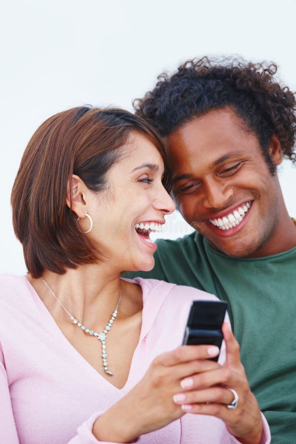 Laughing Young Couple Texting a Message Stock Photo - Image of natural ...