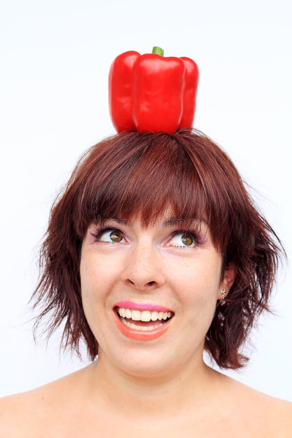 A Laughing Young Woman with a Red Bell Pepper on Her Head Stock Photo ...
