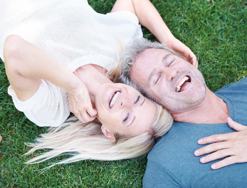 Laughter on the Cool Grass. a Mature Couple Lying on the Grass Smiling ...