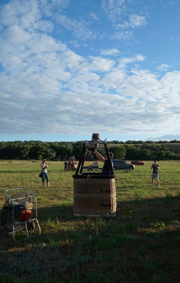 Inflating a Balloon Lying on the Grass with Burning Air Editorial Stock ...