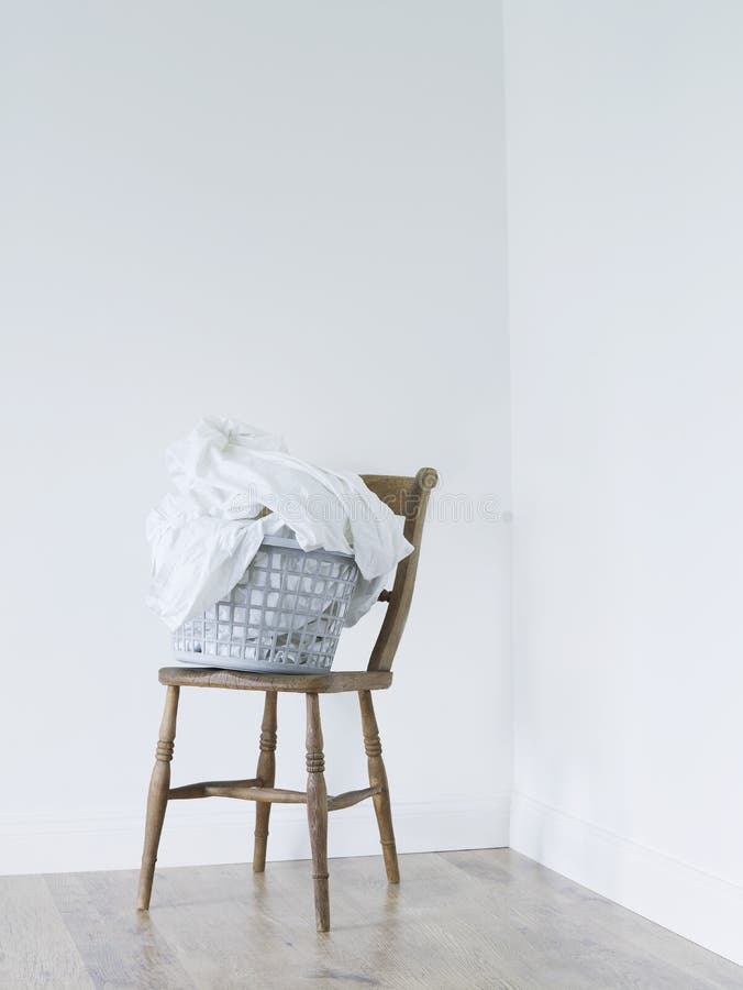 Laundry Basket on Chair in Room Stock Photo - Image of london, chores ...