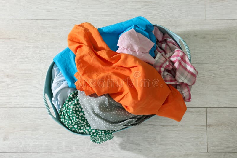 Laundry Basket with Clothes on White Floor, Top View Stock Photo ...