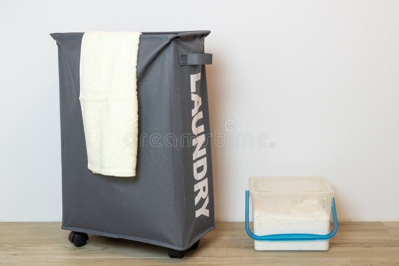 Laundry Basket with Dirty Clothes and Detergent in Container. Copy ...