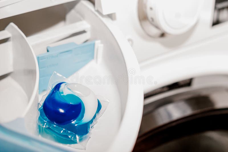 Laundry Blue Capsule in a Washing Machine Stock Image - Image of ...