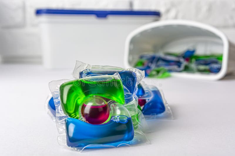 Laundry Capsules and Plastic Containers Isolated on White Background ...