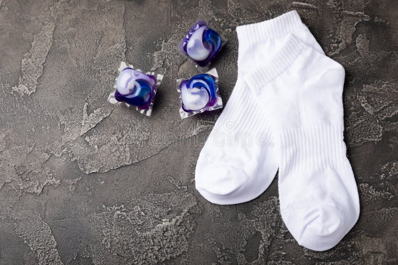 Laundry Capsules and White Clean Socks Stock Photo - Image of hand ...