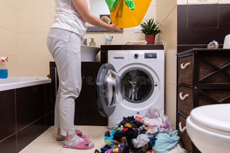 Laundry Day a Person is Loading Clothes into the Washer As Part of ...