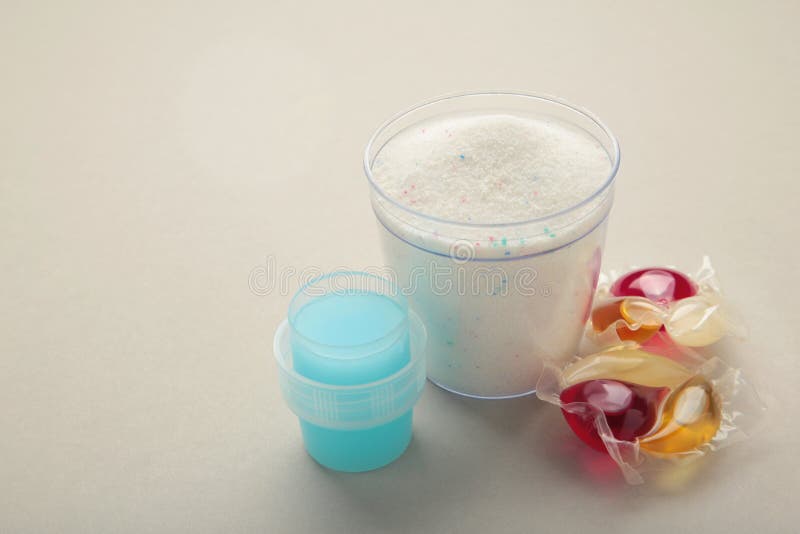 Laundry Detergents with Washing Powder and Capsules on Grey Background ...