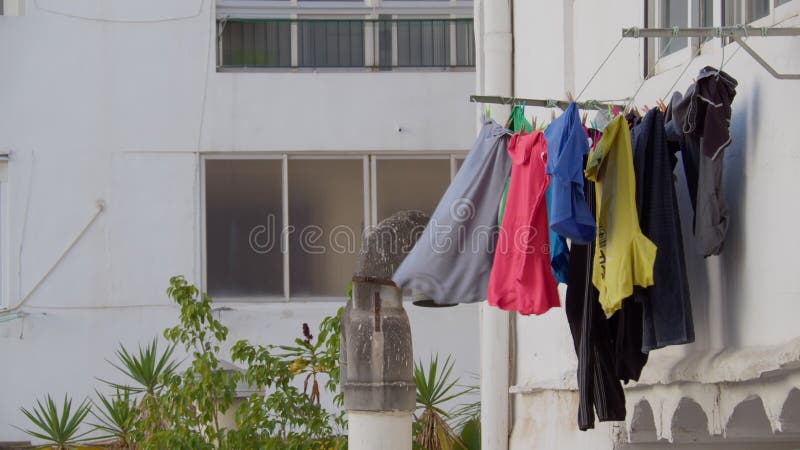 Laundry Drying in the Wind Against White Wall Stock Footage - Video of ...