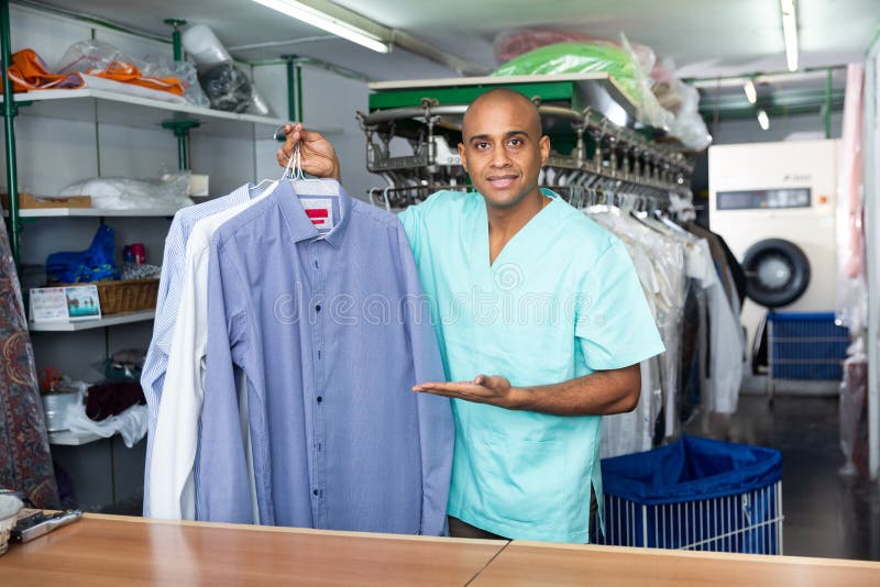 Laundry Male Worker Demonstrates Clean Clothes Stock Image - Image of ...