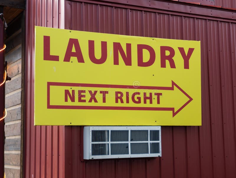 Laundry Next Right Sign stock photo. Image of exterior - 132148122