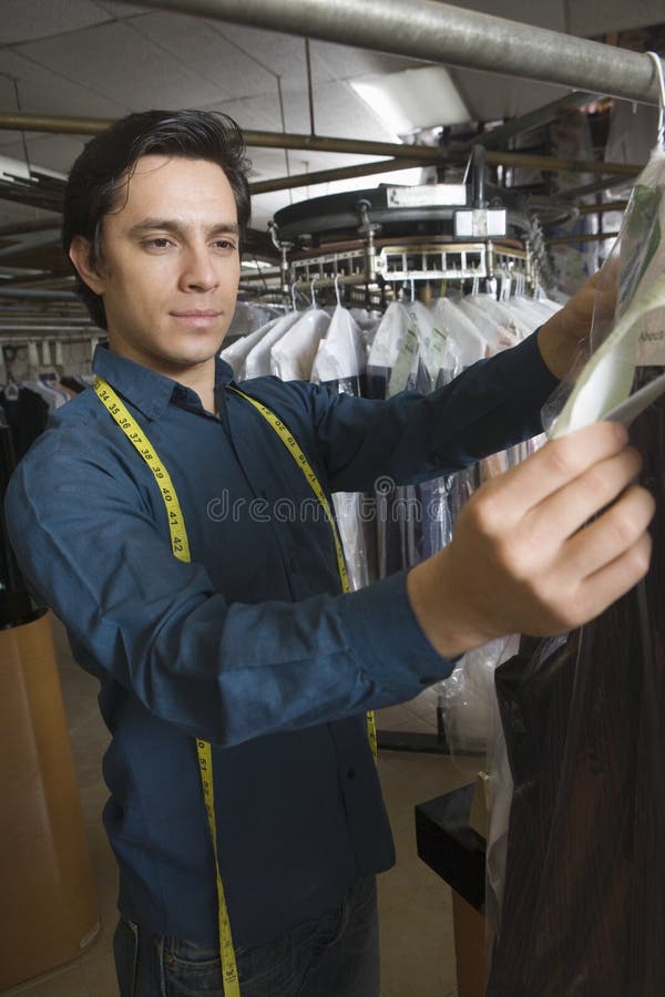 Laundry Owner Checking Clothes Stock Image - Image of male, hispanic ...