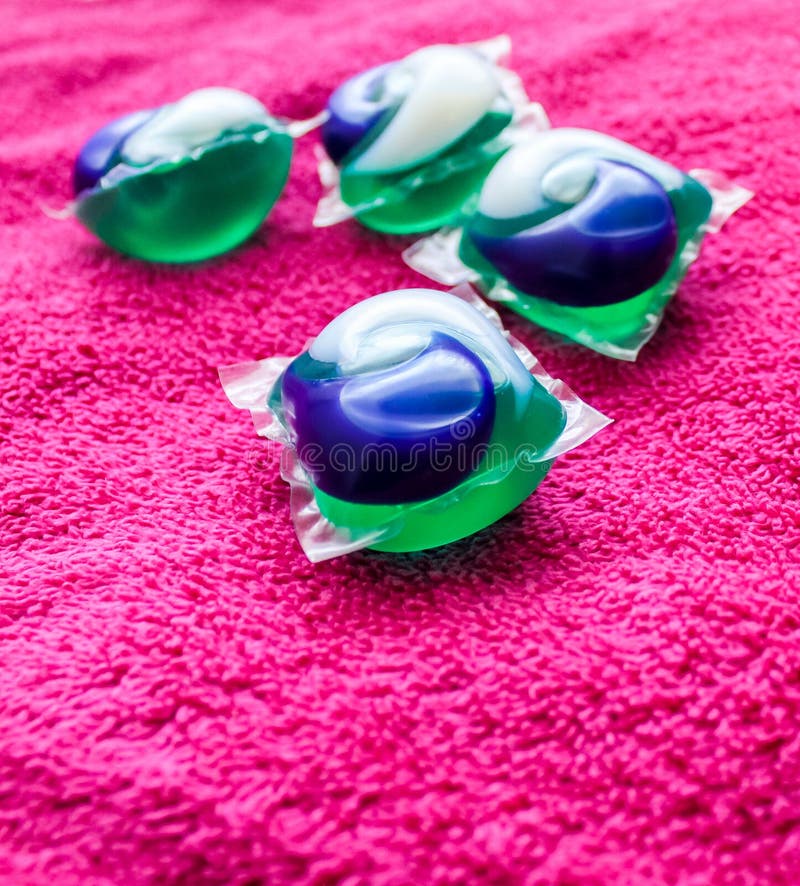 Laundry Pods on a Pink Towel Stock Image - Image of blue, cleaner ...
