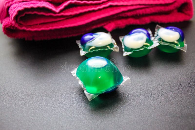 Laundry Pods and Pink Towels Stock Image - Image of towels, product ...