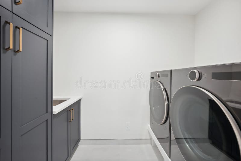 Laundry Room with a Silver Washer and Dryer Stock Photo - Image of ...