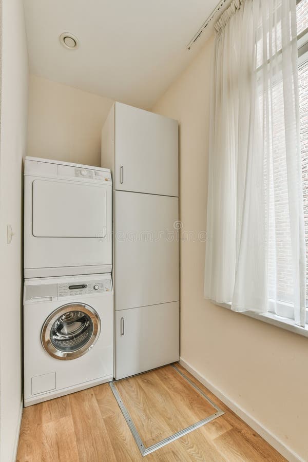 A Laundry Room with a Washing Machine and a Refrigerator Stock Photo ...