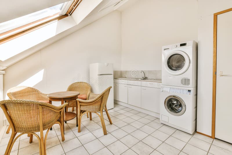 A Laundry Room with a Washing Machine and a Table Stock Image - Image ...