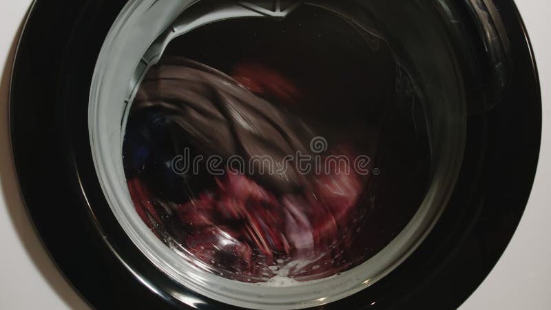 Laundry Service. Colored Dirty Linen Spinning Inside Washing Machine ...