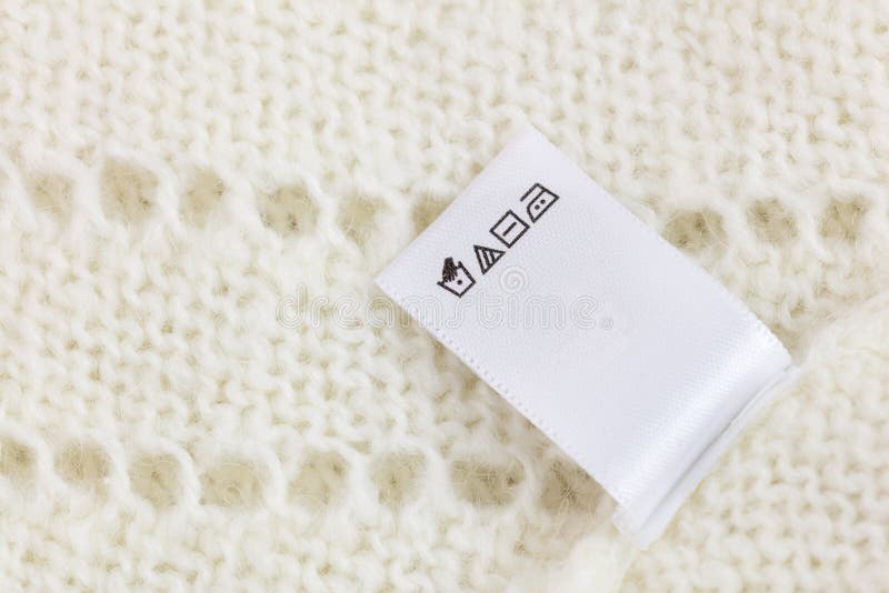 Laundry Tag on White Knitted Wool Sweater Background Stock Image ...
