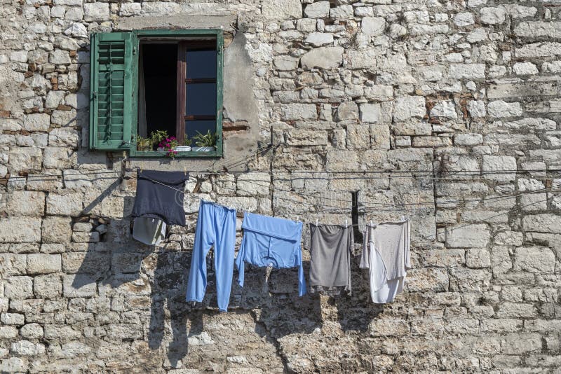 Laundry Under the Damaged Green Window Stock Photo - Image of ...